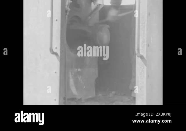 Jewish refugees travel in a train and pass sheep and a boat on a river ...