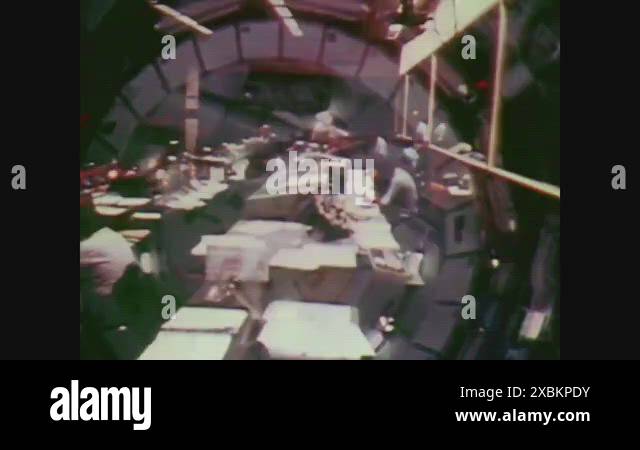 Flight controllers are shown in the Mission Control Center as well as ...