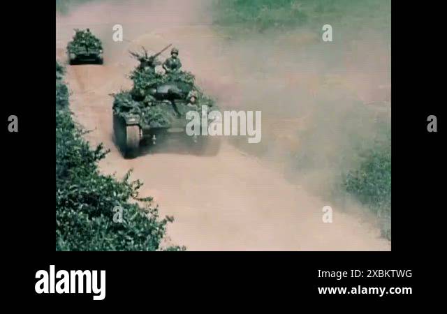 Tanks and trucks advance and South Vietnamese troops move across a ...
