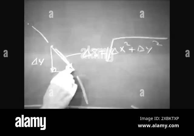 A physics teacher writes on a chalkboard and inserts a magnetic card ...