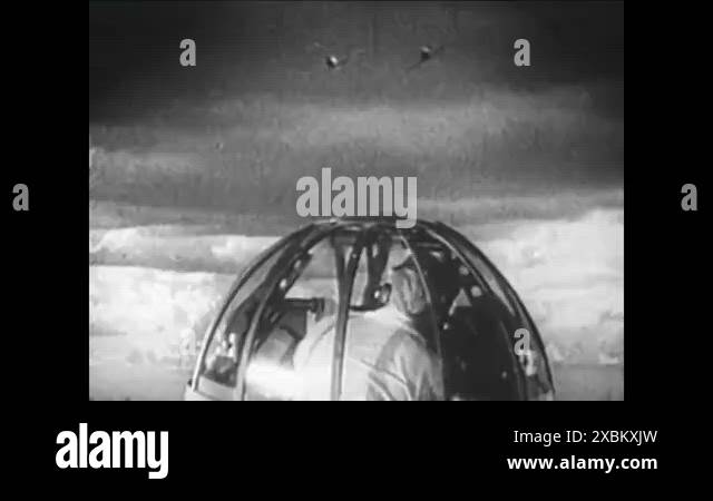 A tail gunner shoots down a Japanese warplane from a Consolidated B-24 ...