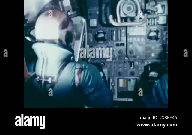 Astronauts are shown operating flight control instruments in the ...