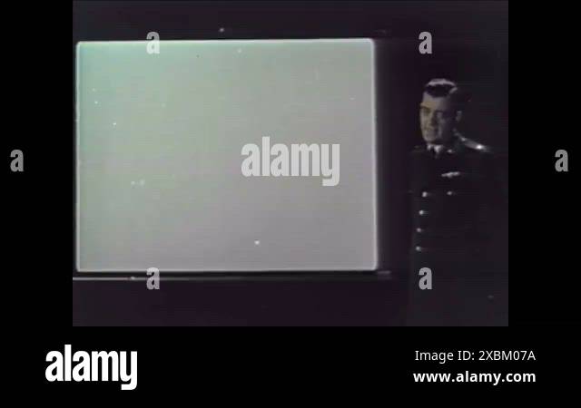 An instructor screens a film showing a downed pilot adrift at sea in a ...