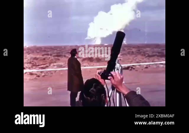 A Little Joe II rocket is launched as spectators watch and a crash ...