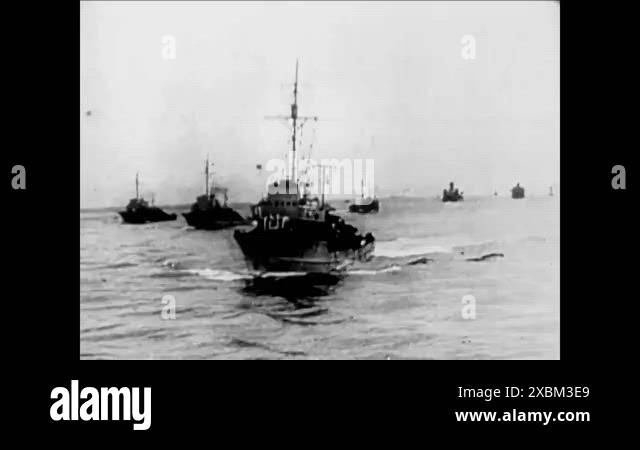 A naval operator boards a Neger that is lowered over the side of a ship ...
