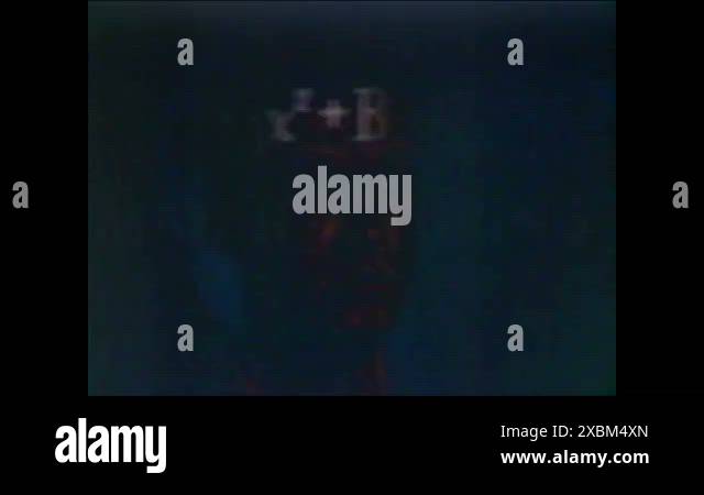 1963 - In this animated sequence, equations are projected onto a man's ...