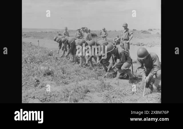 1943 - American soldiers disassemble land mines and engage in combat in ...