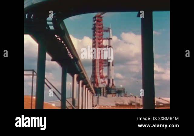 1967 - The Apollo 4 is seen on a launch pad while a narrator lists its ...