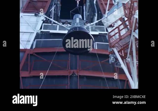 1959 - The Atlas booster is attached to the test capsule for a launch ...