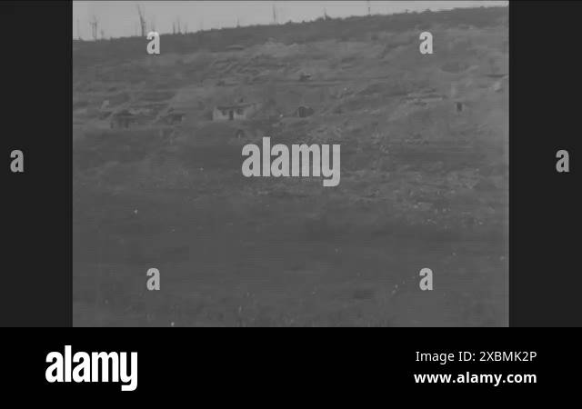 1918 - Hillside gun emplacements are shown and a soldier smokes in a ...