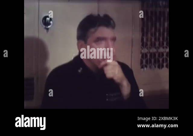 1967 - Actor Chris Bohn speaks as officers play chess aboard a United ...