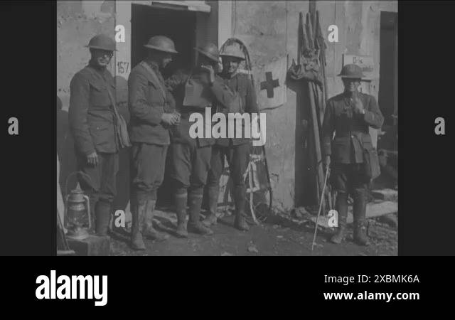 1918 - Soldiers smoke cigarettes, fill canteens and an ambulance is ...