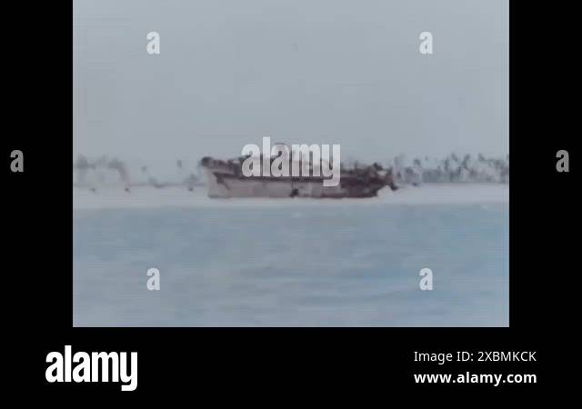 1944 - While under fire from the Japanese army, the Marines conduct an ...