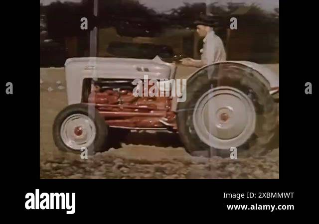 1953 - A farmer works acreage with a Ford Golden Jubilee tractor, and a ...