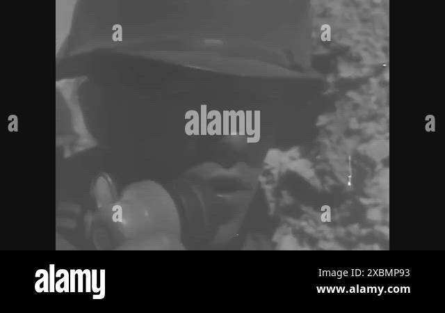 1957 - Scenes of an atomic blast, and soldiers crouch in trenches Stock ...