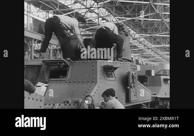 1941 - Laborers install caterpillar tracks onto tanks, and tanks are ...