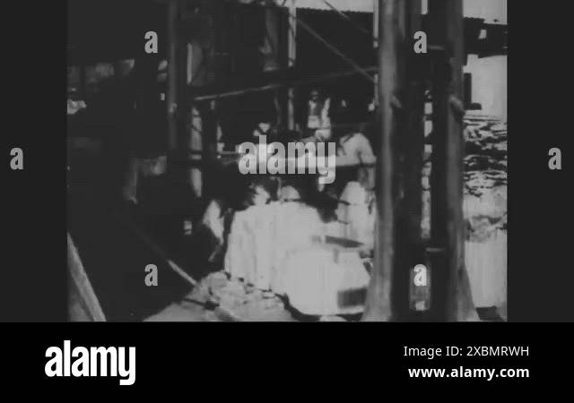1906 - Italian sculptors chisel marble into religious statues Stock ...