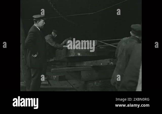 1923 - Shipyard workers push and pound a launching sliding beam into ...