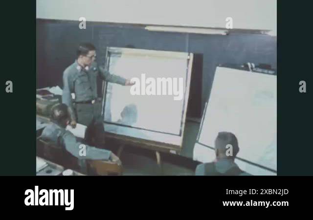 1967 - An army officer explains a map to a room of other officers ...