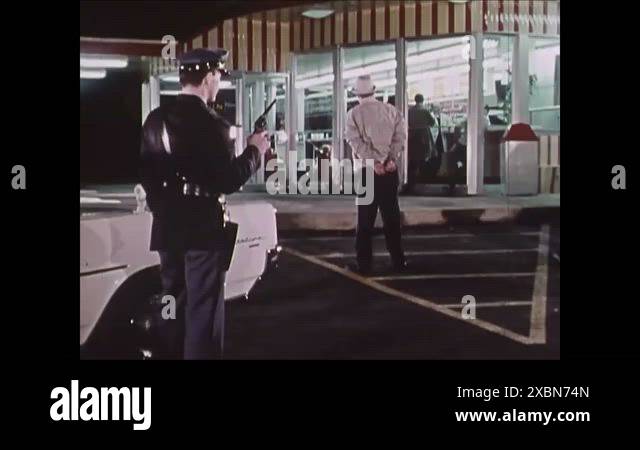 1969 - A cop demonstrates the proper way to put an arrested criminal ...