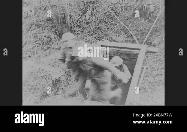 1917 - A gun detachment emerges from a dugout and fires an artillery ...