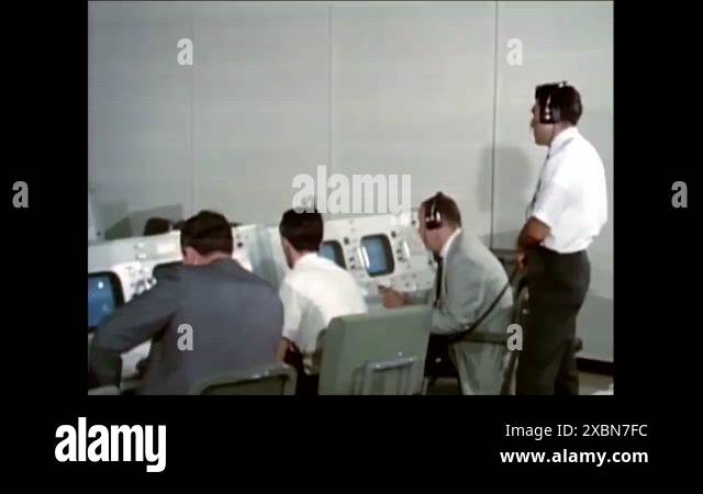 1966 - Work is shown in NASA's auxiliary control room during a space ...