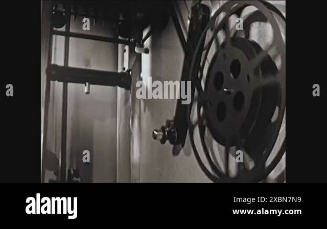 1958 - A film lab processor shows how wax is put on film strips to ...