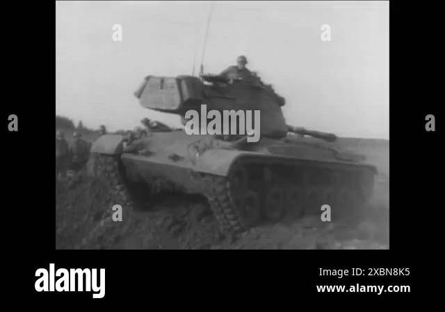 1950 - Tanks are maneuvered over craters and the 2nd armored division ...