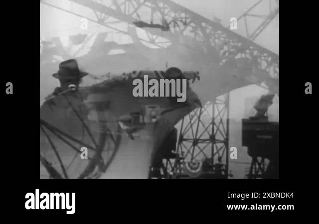 Two blimp pilots overlook the USS Forrester from the air, admiring its flight decks and ...
