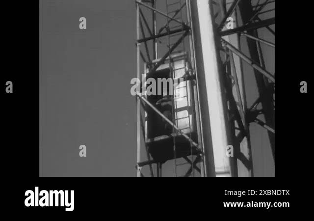 An electrical engineer ascends in an elevator, enters a control room ...