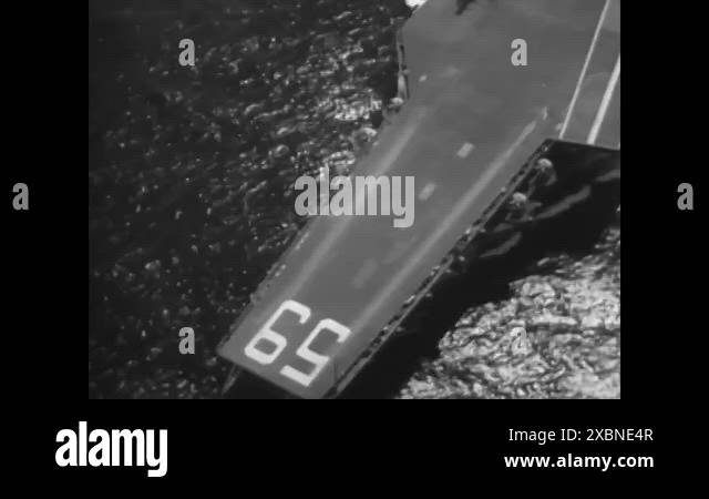 Men in the engine room of the USS Forrestal are shown as they send the ...