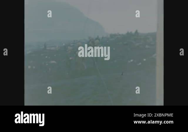 1945 - Marines work in stormy weather and transport equipment and the ...
