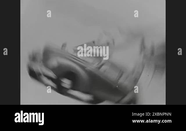 1951 - Drum majorettes, a marching band, a military truck carrying ...