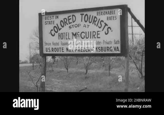 1943 - A billboard advertising a hotel for colored tourists, a landmark ...