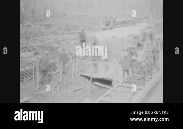 1918 - Soldiers transport ammunition using pontoons on the Scarpe River ...