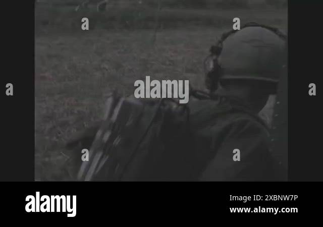 1960s, 1970s - UH-1D helicopters drop off soldiers in a field and fly ...