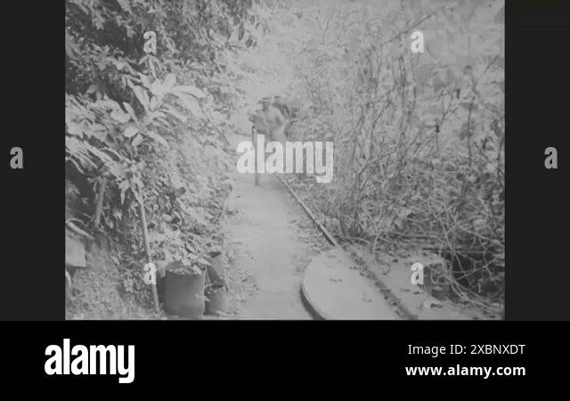 1941 - General Jonathan Wainwright looks at a map and soldiers rush to ...