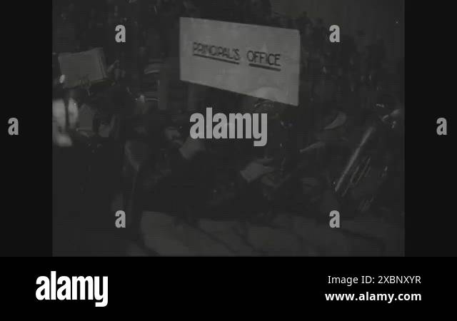 1944 - A principal meets with a student and students are shown in auto ...