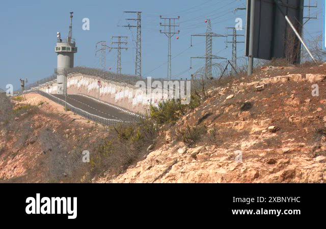 Guard towers monitor activity along the new West Bank Barrier between ...