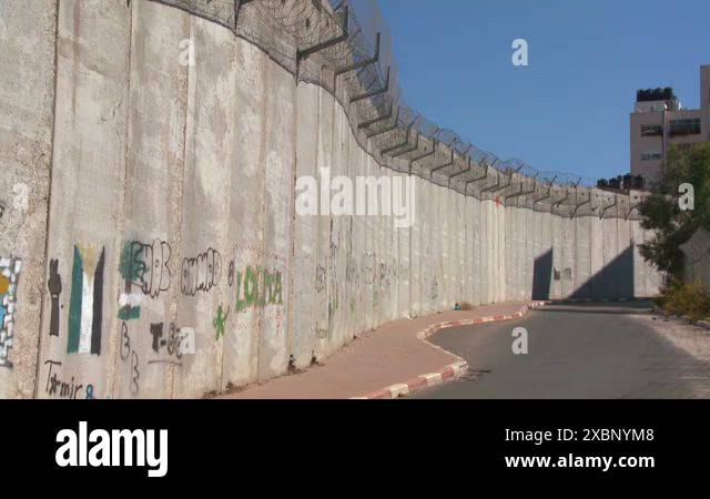 Graffiti is drawn on the new West Bank Barrier between Israel and the ...