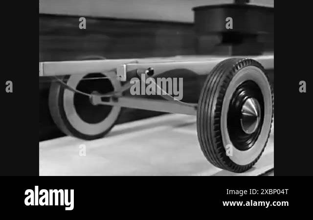 1938 - A rigid beam and a spiral spring are used in an apparatus with ...