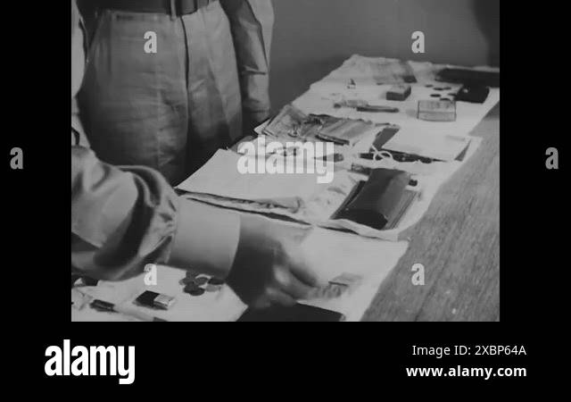 Two Air Interrogation Officers look at the personal belongings ...