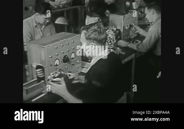 A young man tests the coin-operated mechanism in a jukebox at a ...