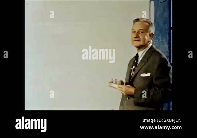 Roy Larson, architect, draws on a big white board and talks about ...