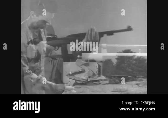 Army soldiers fire weapons on an outdoor military firing range and the ...