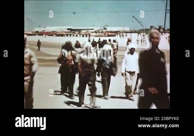 Arab workers are shown learning the different processes of construction ...