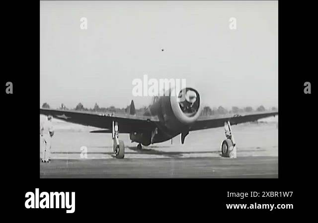 A flight crew chief, acting as an air marshall, signals the pilot of a ...