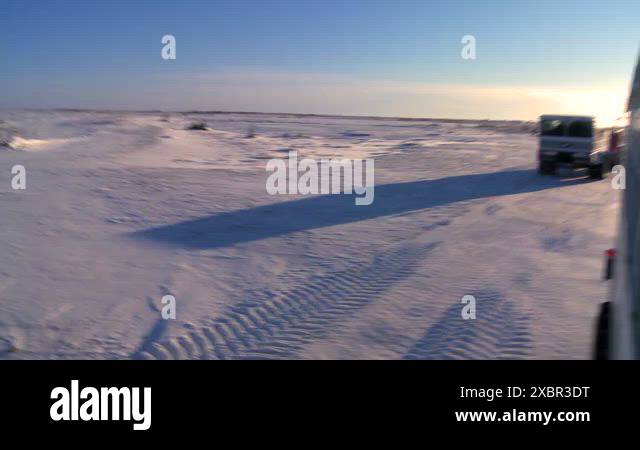 An arctic crawler tundra buggy moves across the frozen expanse of ...