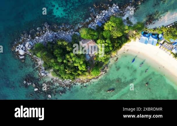 Aerial view of a tropical island with turquoise water and lush green ...