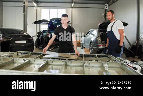 Technician Engages In Troubleshooting EV Car Battery Cell Module. Two ...